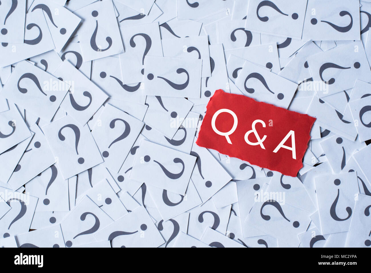 question mark on white paper and Q&A on red paper. questions and answer ...