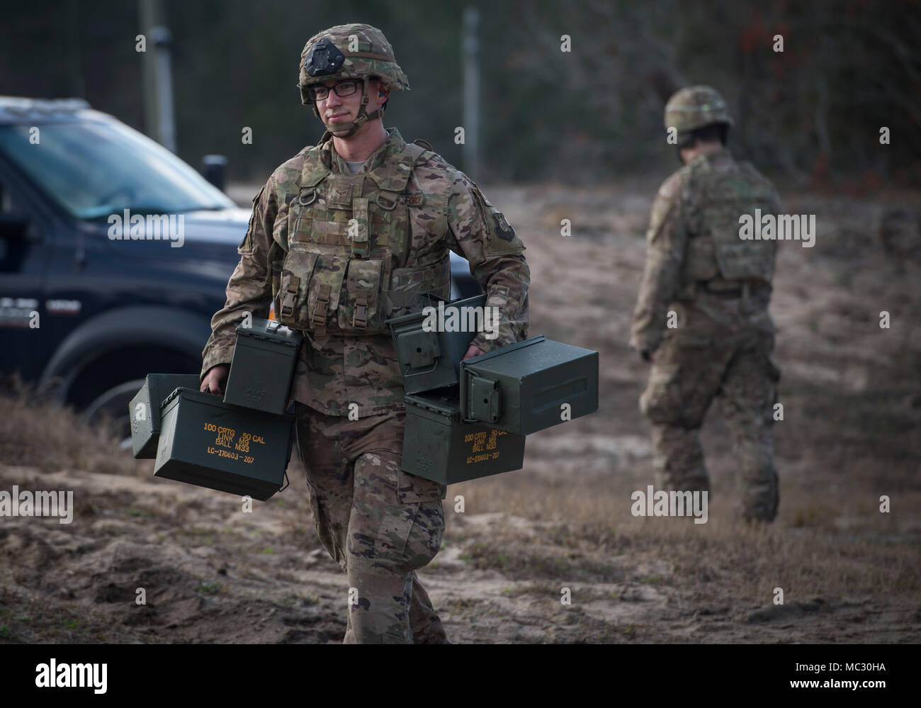 An Airman from the 824th Base Defense Squadron carries empty ammunition ...