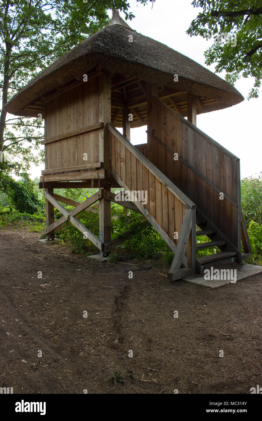 Observation tower for bird watching at the pond. In the background are ...