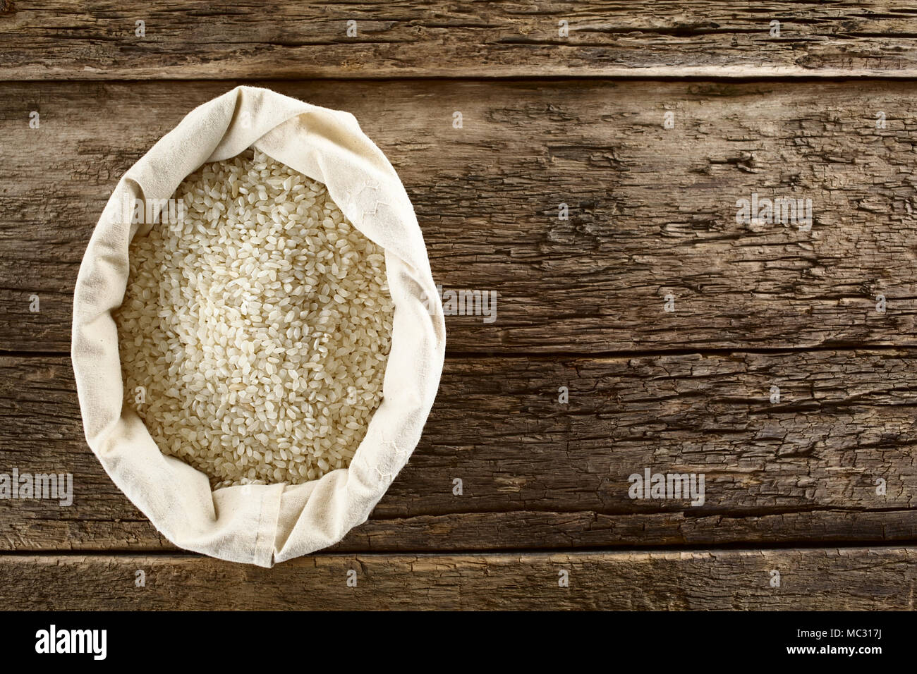 Raw arborio risotto short-grain rice in bag, photographed overhead on ...