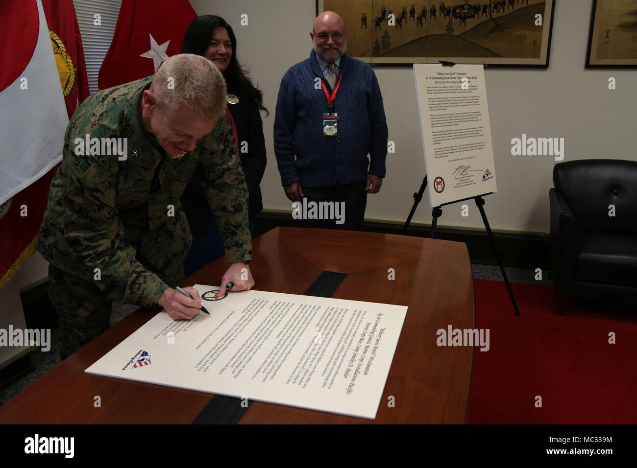 CAMP FOSTER, OKINAWA, Japan – Brig. Gen. Paul Rock Jr. signs the ...
