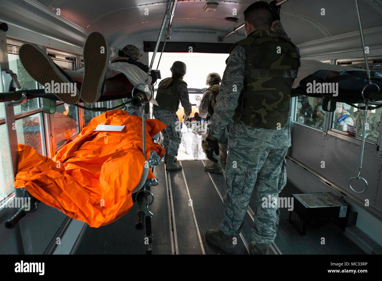A simulated patient is loaded for transportation during a joint field ...