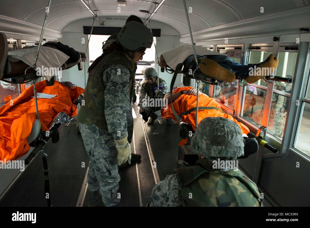 A simulated patient is loaded for transportation during a joint field ...