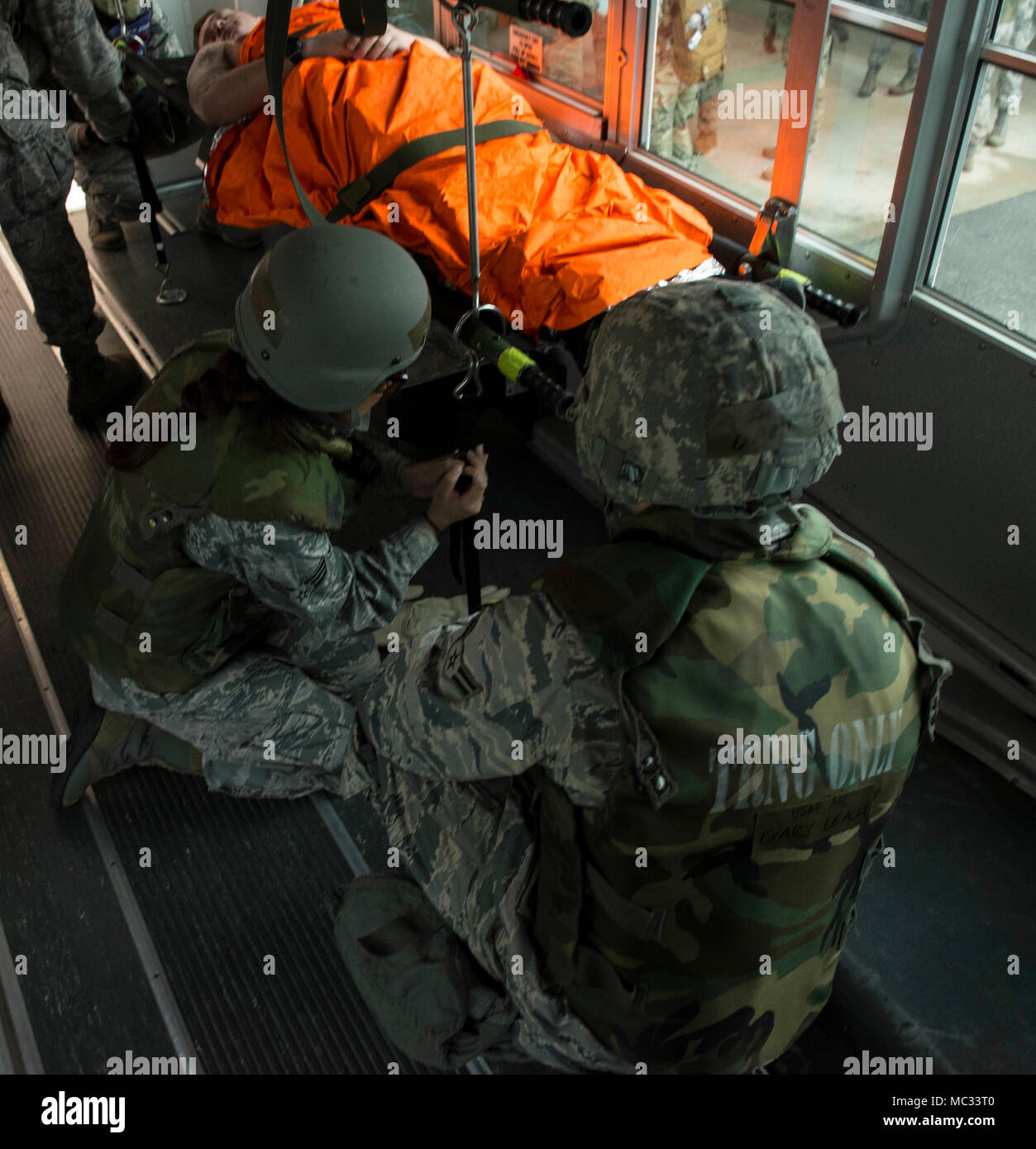 A simulated patient is loaded for transportation during a joint field ...
