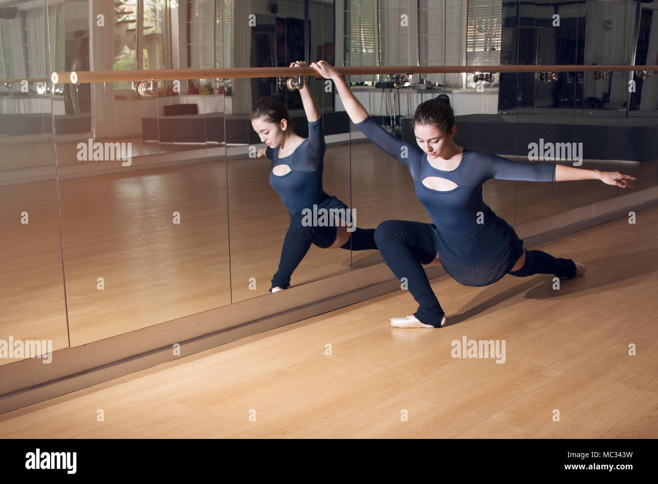 Beautiful ballerina practicing at the barre Stock Photo - Alamy