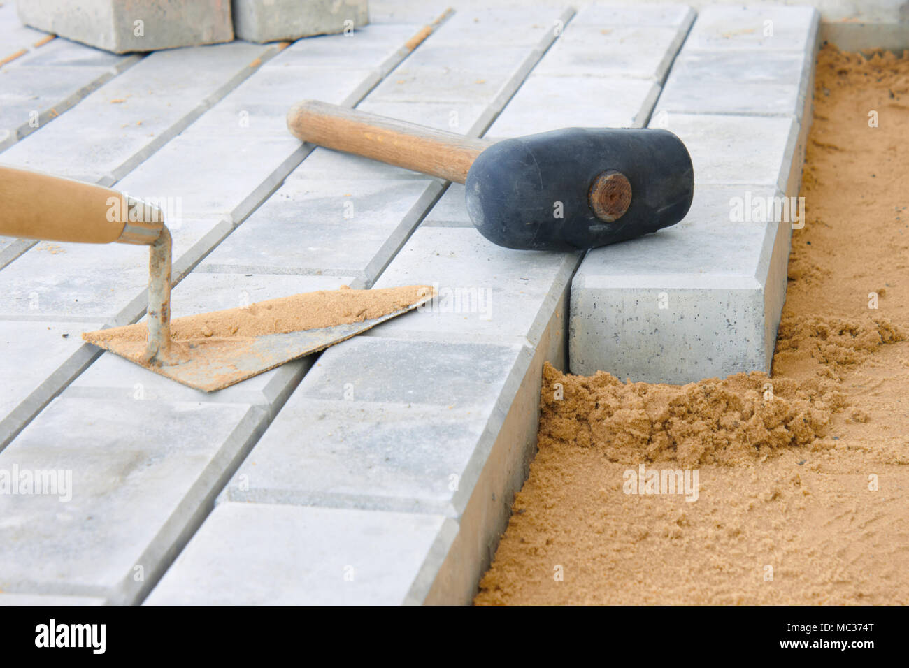 Stone blocks laying down on a sandy basis Stock Photo - Alamy