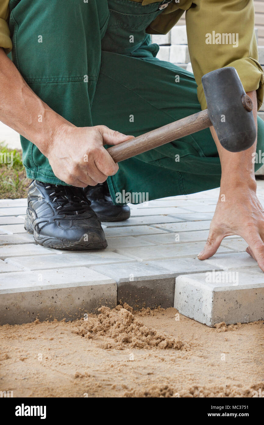 Creating a pavement of stone blocks. Handmade Stock Photo - Alamy