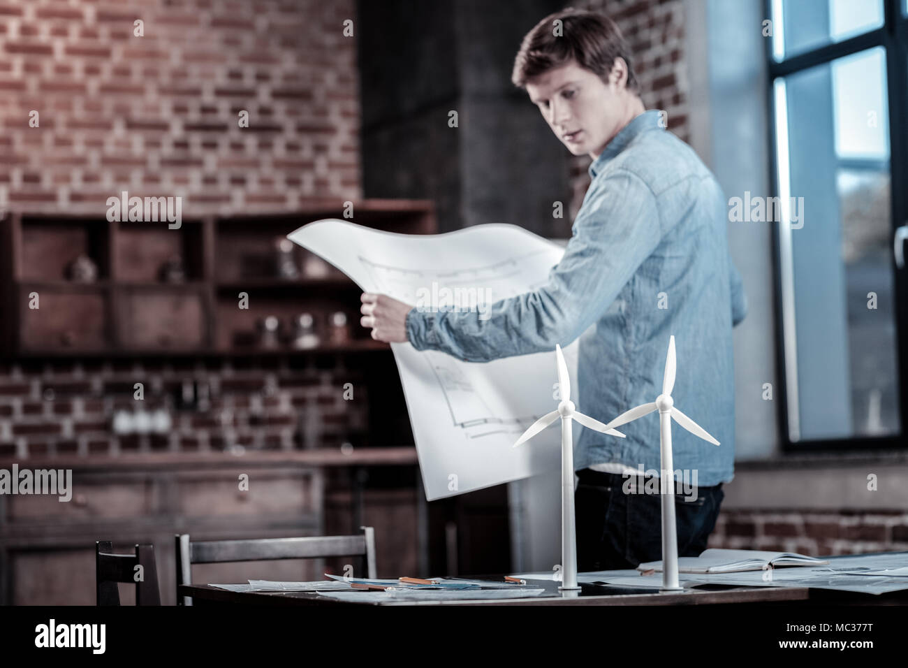 Concerned male engineer turning to model Stock Photo - Alamy