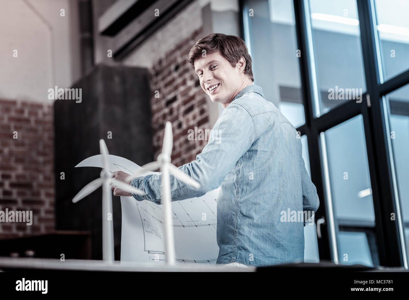 Glad male engineer evaluating his model Stock Photo - Alamy