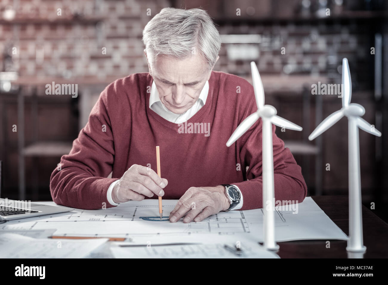 Earnest male engineer drawing plan Stock Photo - Alamy