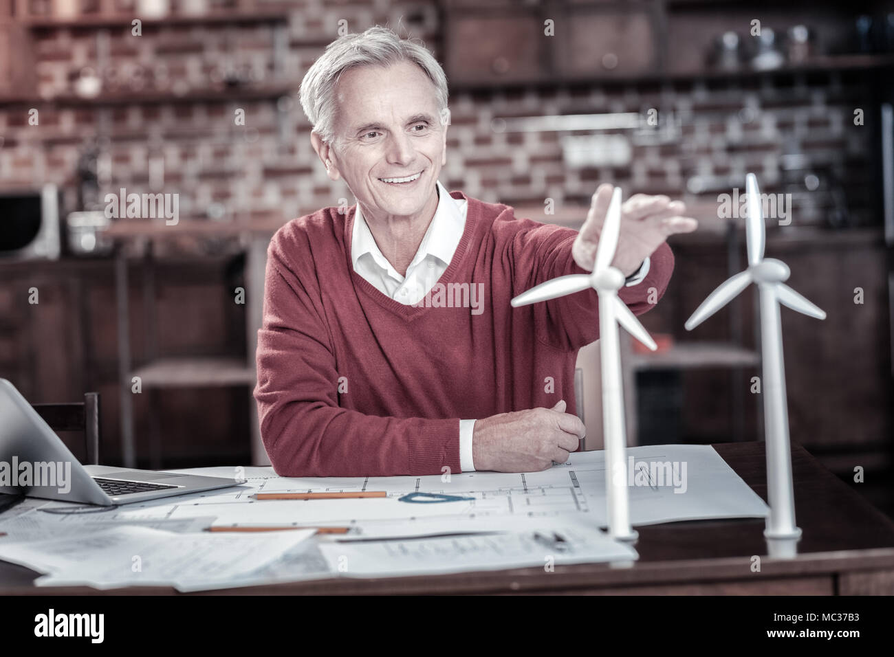 Happy male engineer working on windmill Stock Photo - Alamy