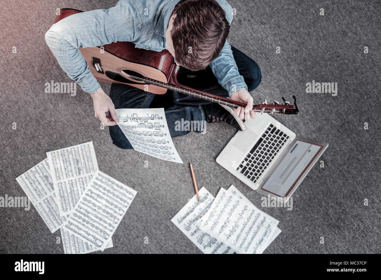 Young successful man learning musical notation Stock Photo - Alamy