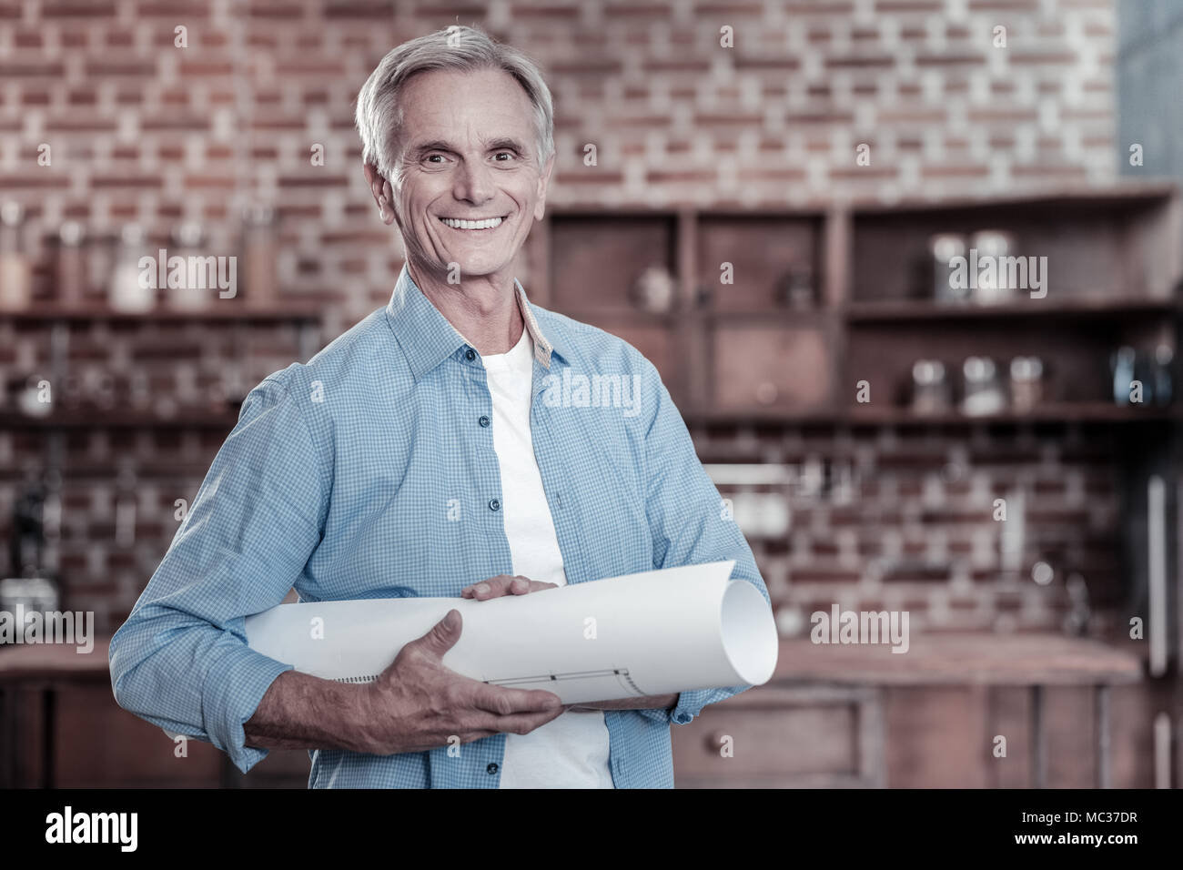 Successful male engineer presenting blueprint Stock Photo - Alamy