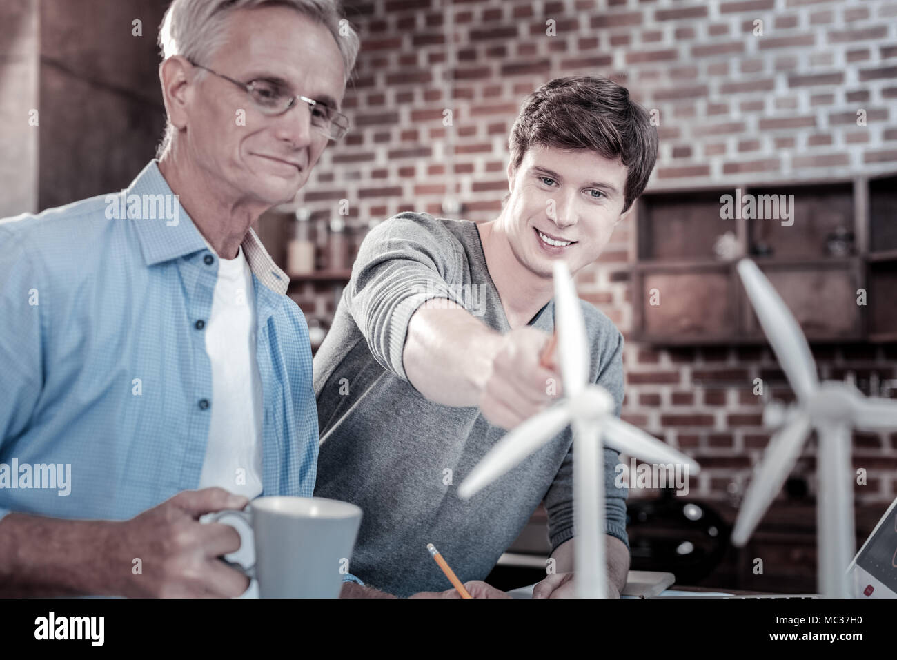 Pleased male engineers making breakthrough Stock Photo - Alamy