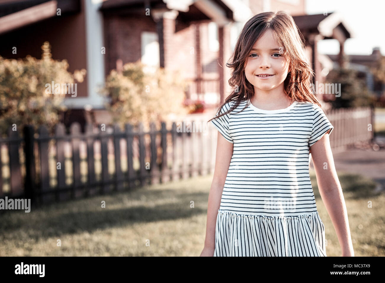 Little pretty girl standing and smiling Stock Photo - Alamy