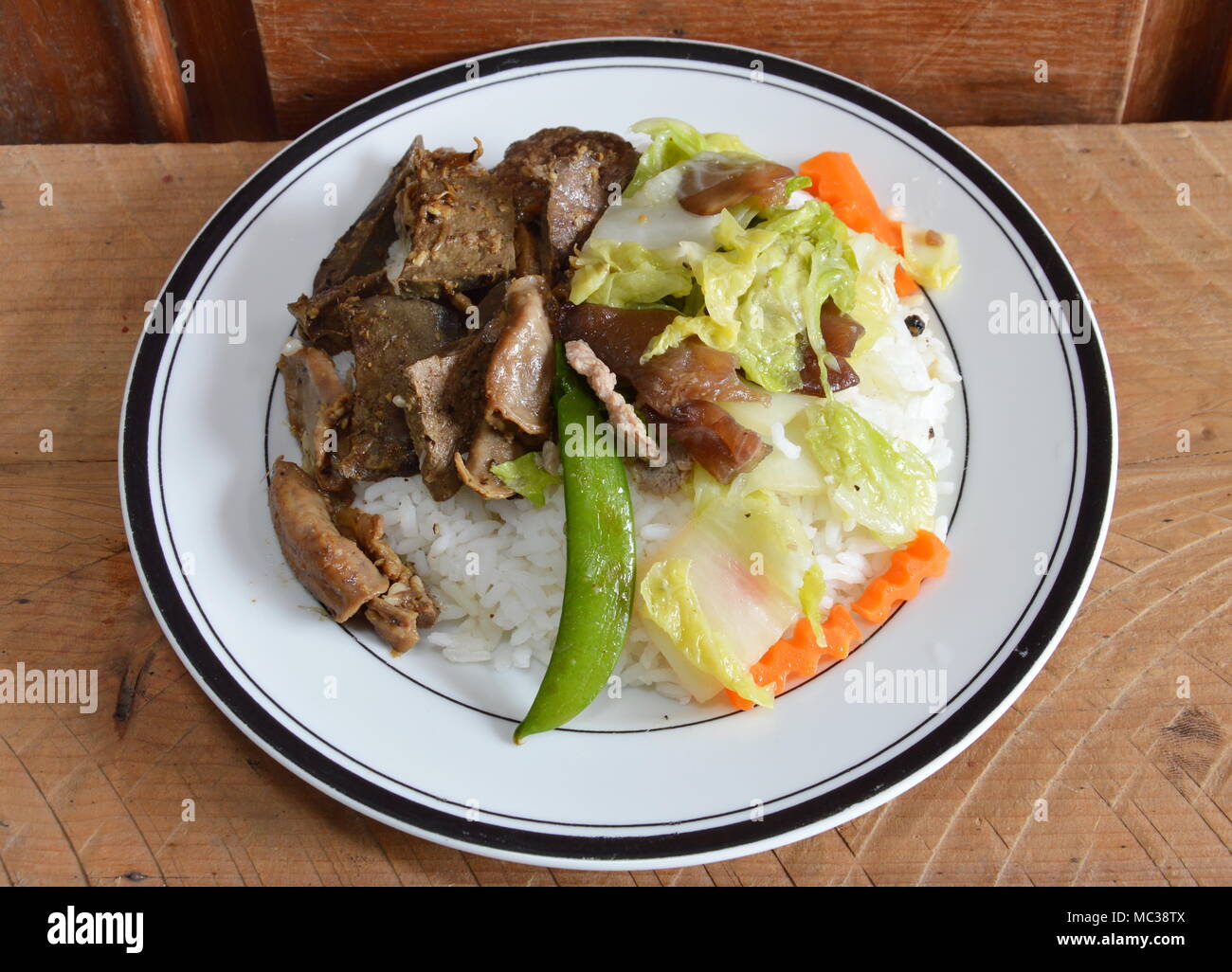 fried pork entrails with garlic and stir-fried mixed vegetable on rice ...