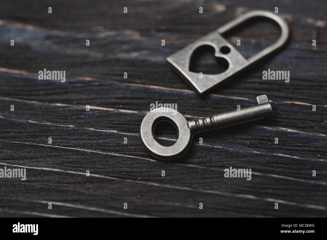 Vintage bronze lock and key on a wooden table. Close-up view Stock ...