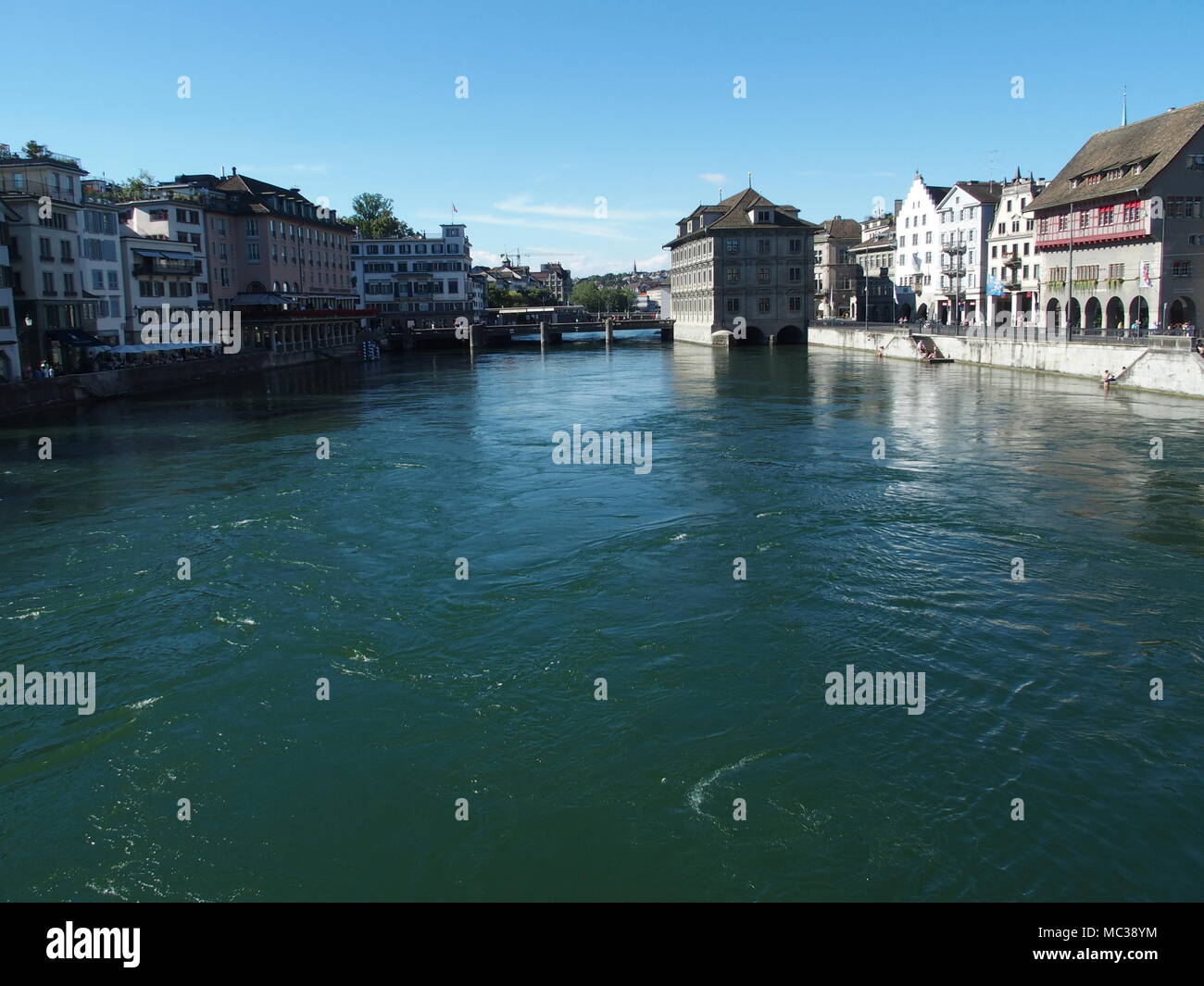 Alpine Limmat River in ZURICH city and buildings on promenade in swiss ...