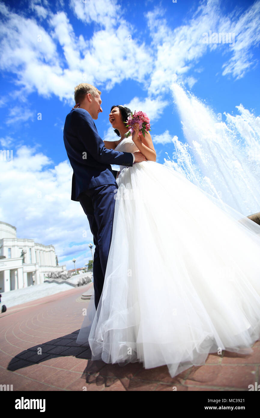 happy bride and groom on the background of the summer sky Stock Photo ...