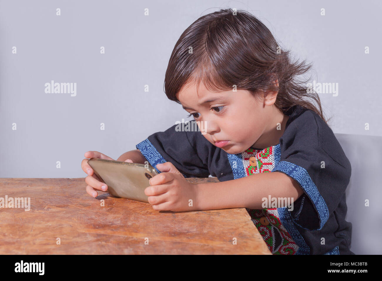 Cute adorable white baby playing with mobile cell phone with funny ...