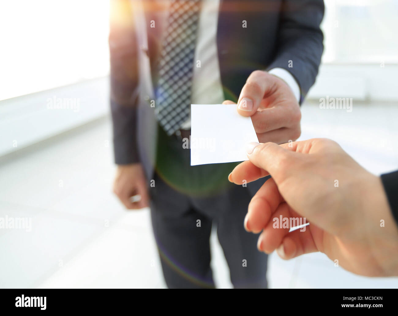 Exchange business card for first time meet Stock Photo - Alamy