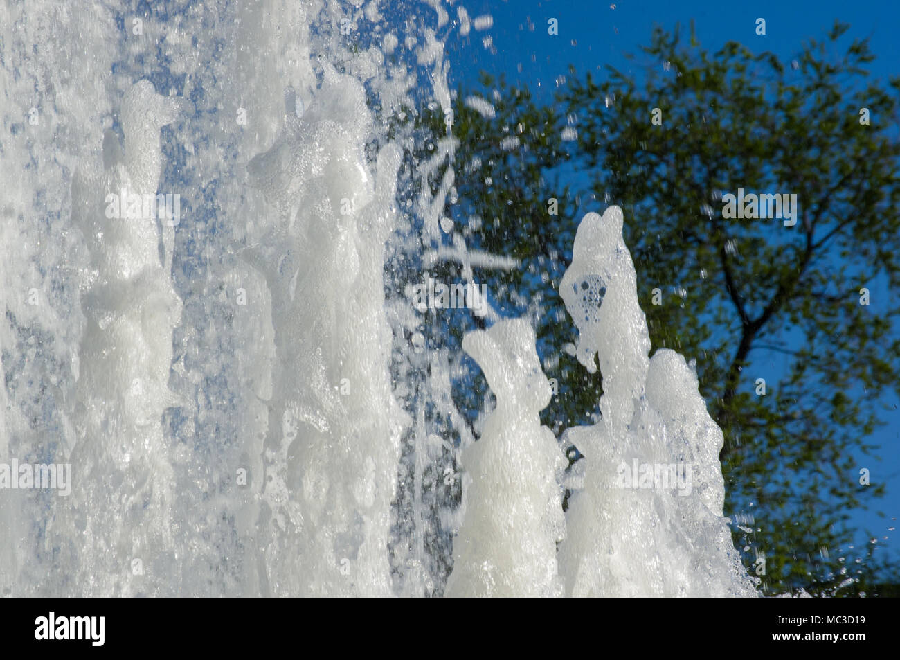Fountain in city park on hot summer day, beautiful bright streams of ...