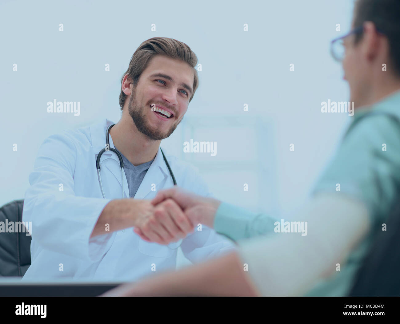 Doctor welcoming a patient in his studio Stock Photo - Alamy