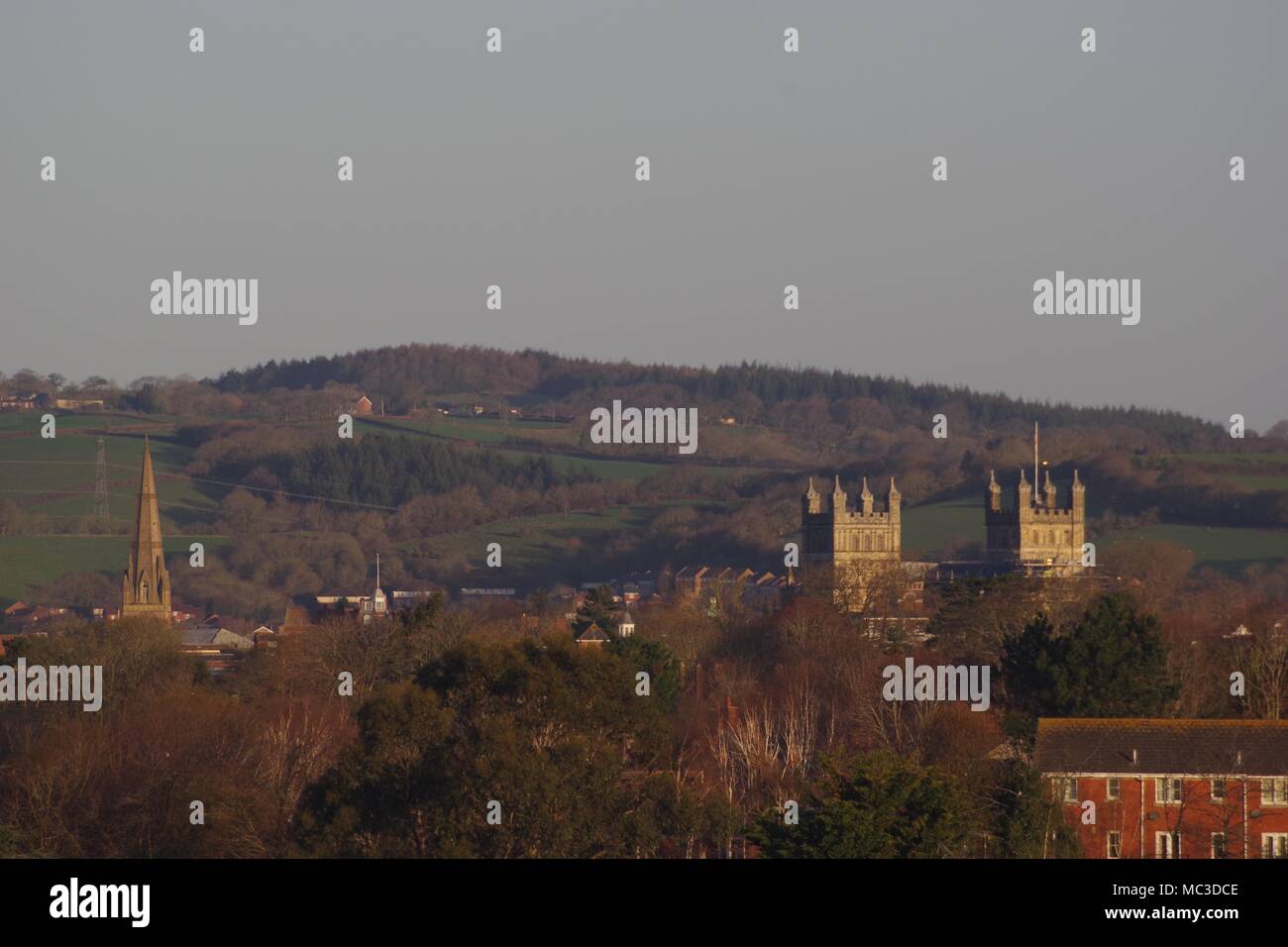 The Norman Towers of Exeter Cathedral and a Church Steeple Dominate the ...