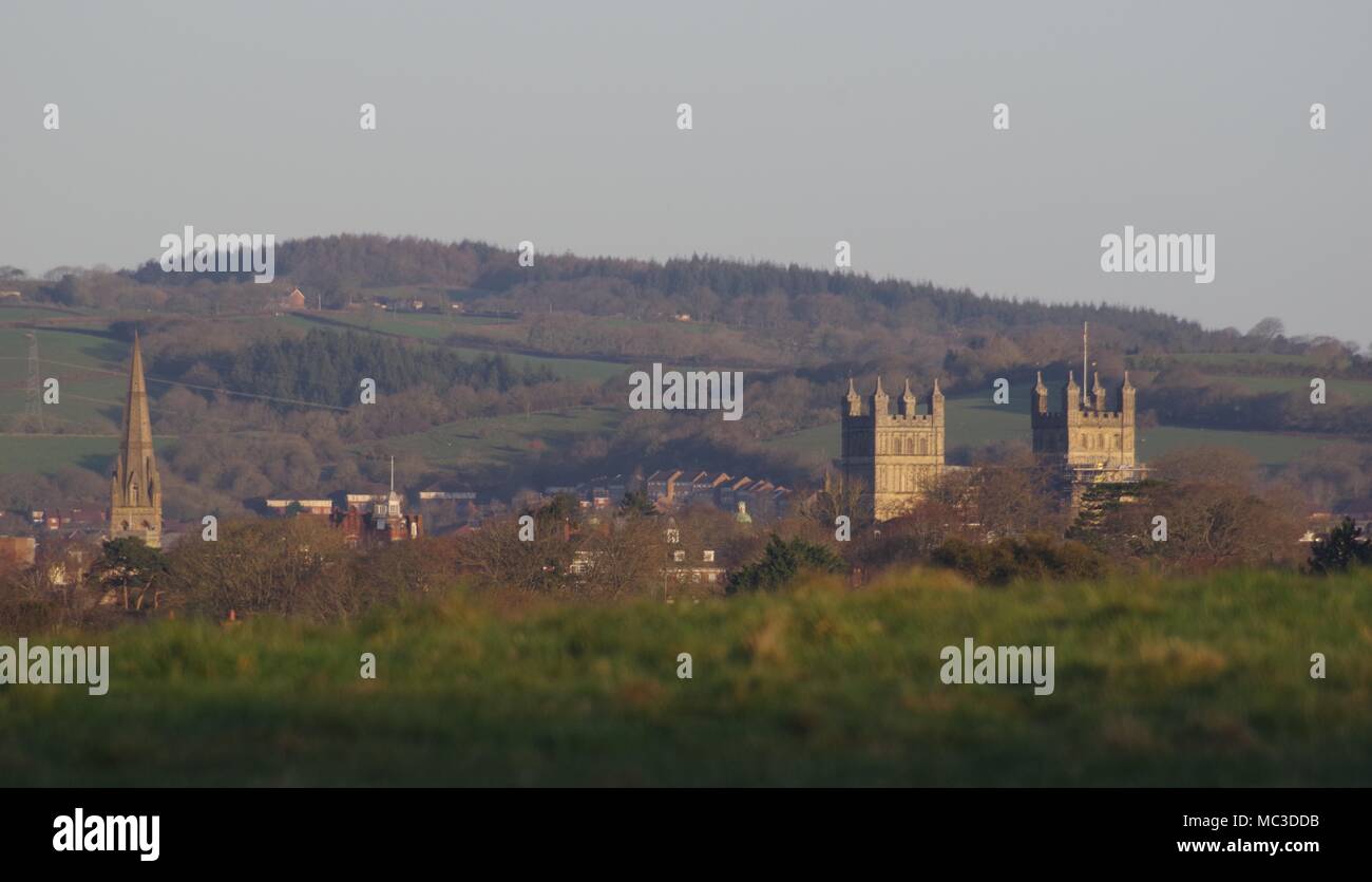 The Norman Towers of Exeter Cathedral and a Church Steeple Dominate the ...