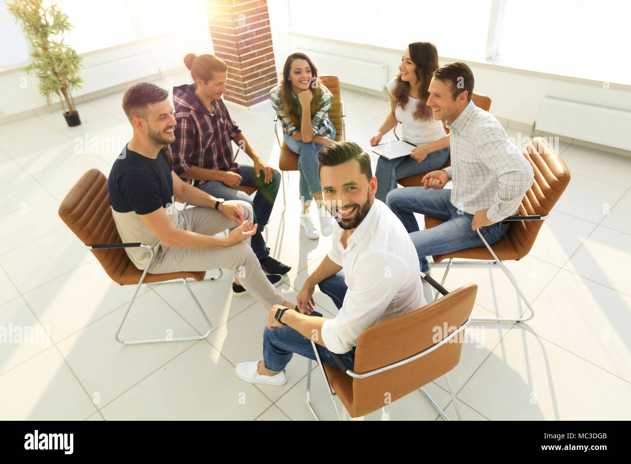Manager and his team sitting in the office Stock Photo - Alamy