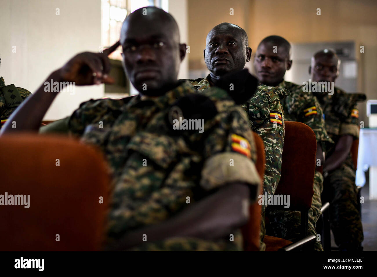 Ugandan People's Defense Force soldiers listen during the Civil ...