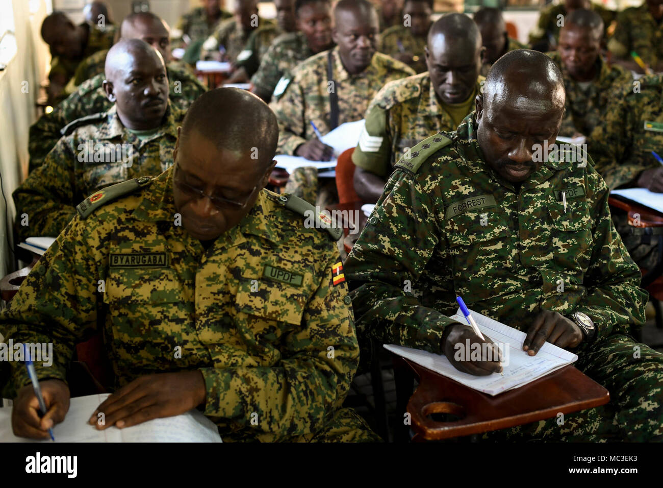 Ugandan People's Defense Force soldiers listen during the Civil ...
