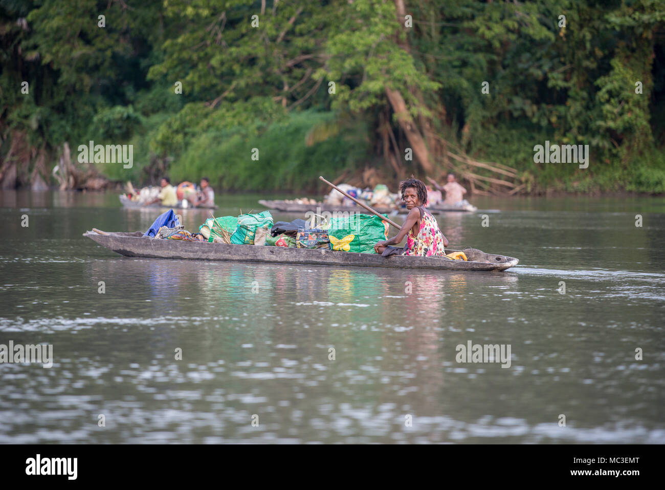 A woman on a dugout canoe on the Sepik River, East Sepik Province ...