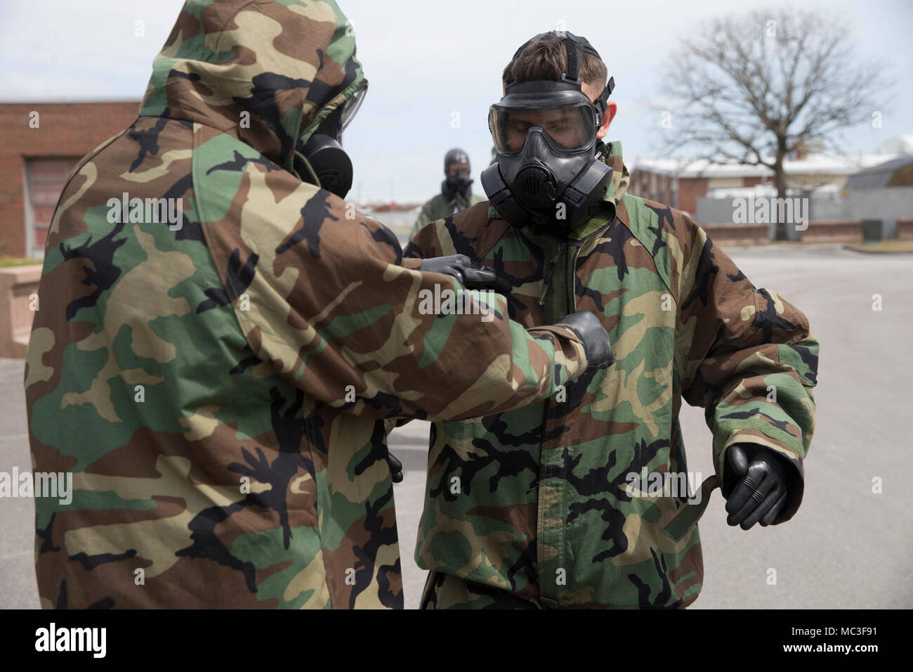 U.S. Marine Corps Lance Cpl. Clayton T. Combs, right, is assisted in ...