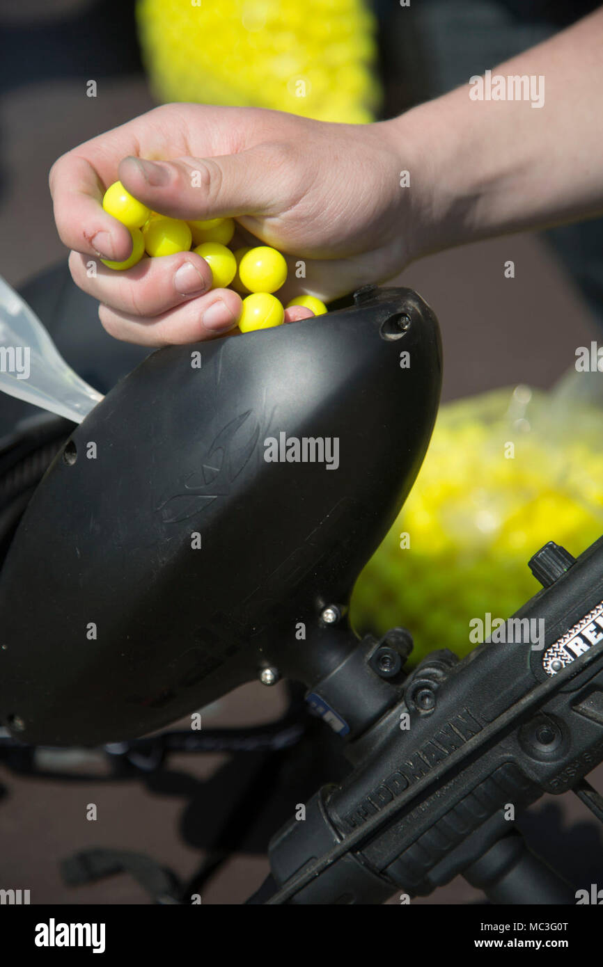 A U.S. Marine loads paintballs into a paintball hopper at Marine Corps ...