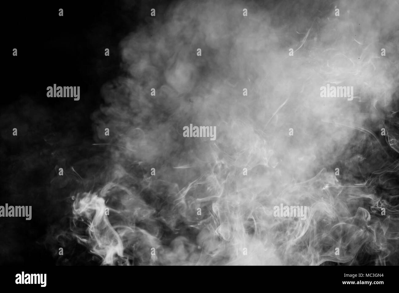 Thick white smoke on a black isolated background. Background from the ...