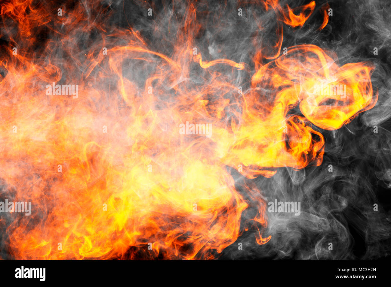 Thick fiary smoke on a black isolated background. Fire flames ...