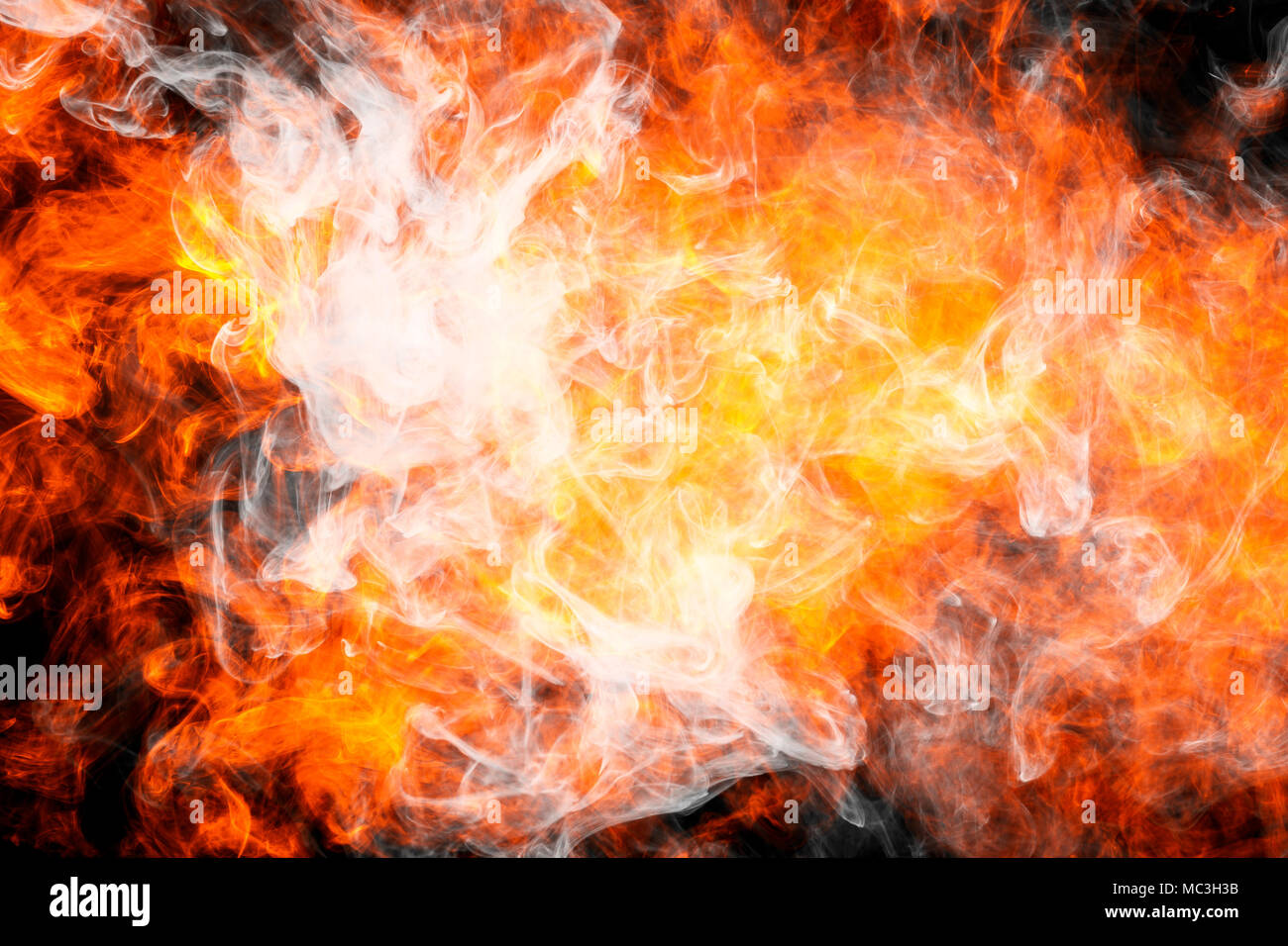 Thick fiary smoke on a black isolated background. Fire flames ...