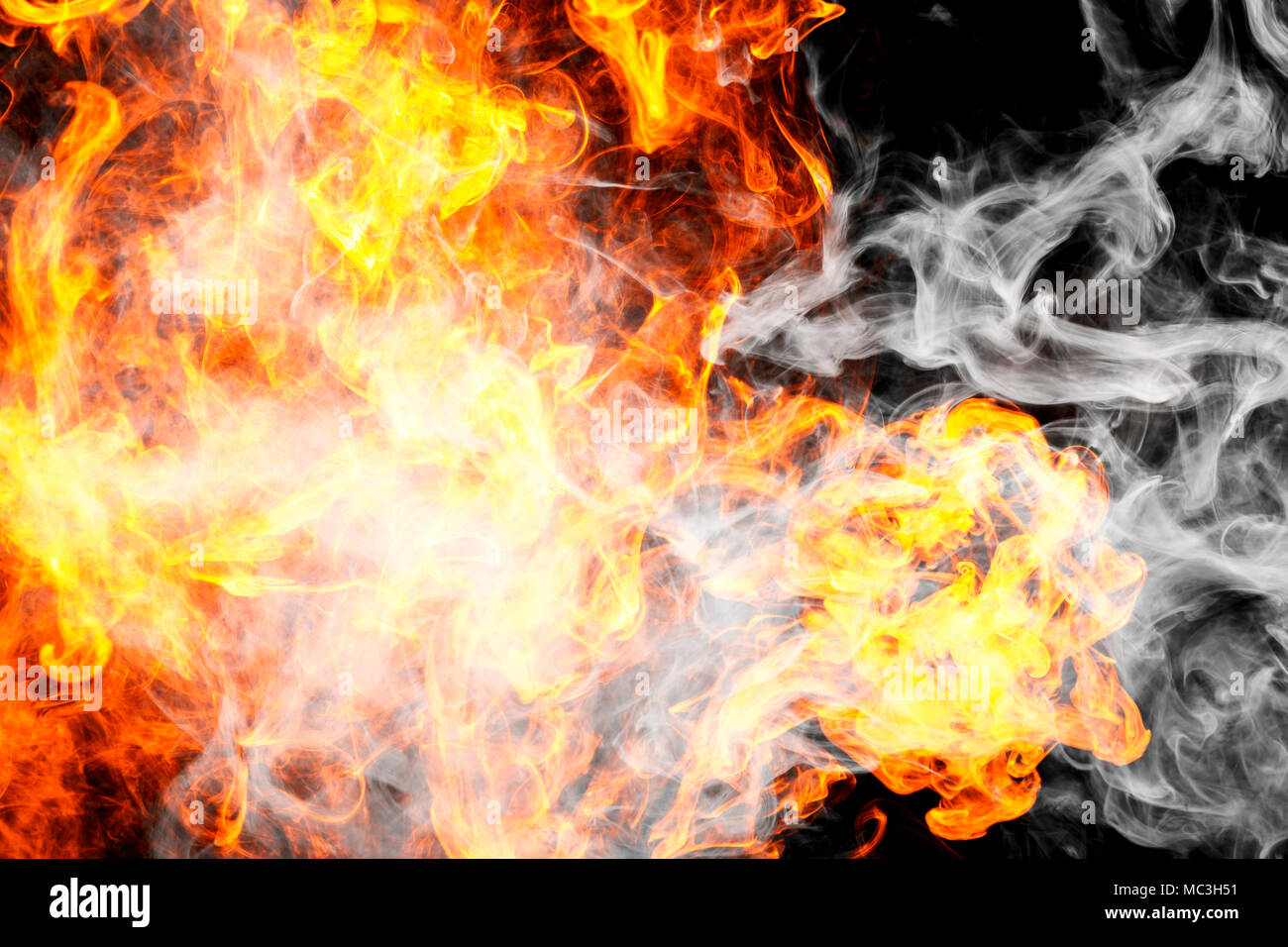 Dense fiery flames smoke on a black isolated background. Background of ...