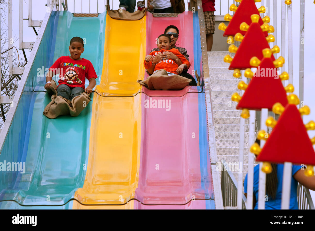 Atlanta, GA, USA - March 15, 2014: A family slides down the fun slide ...