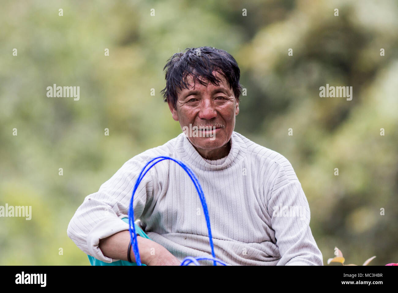 Bhutanese man resting by roadside as seen on a road trip towards ...