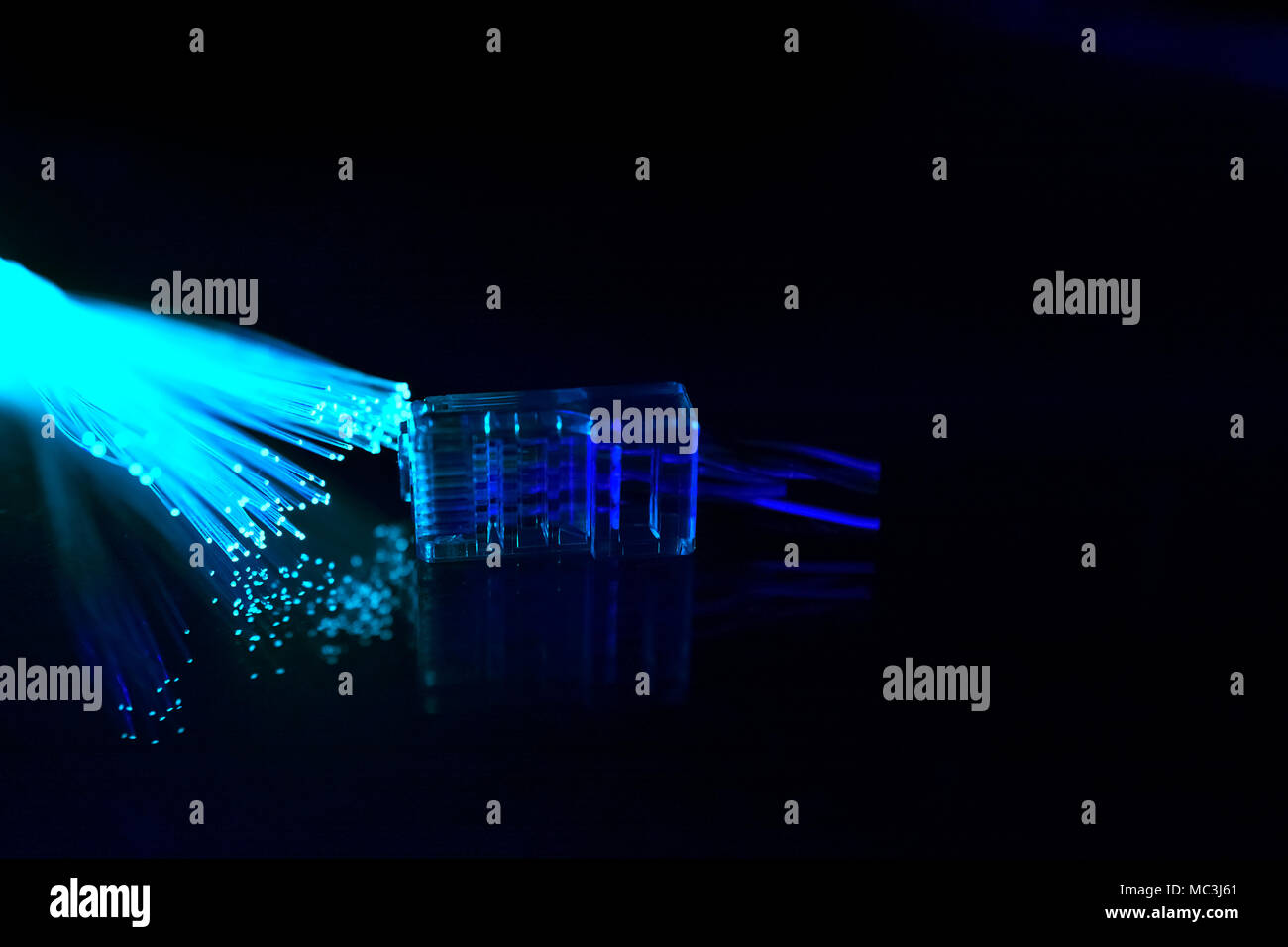 Optical fibre cable against black background Stock Photo - Alamy