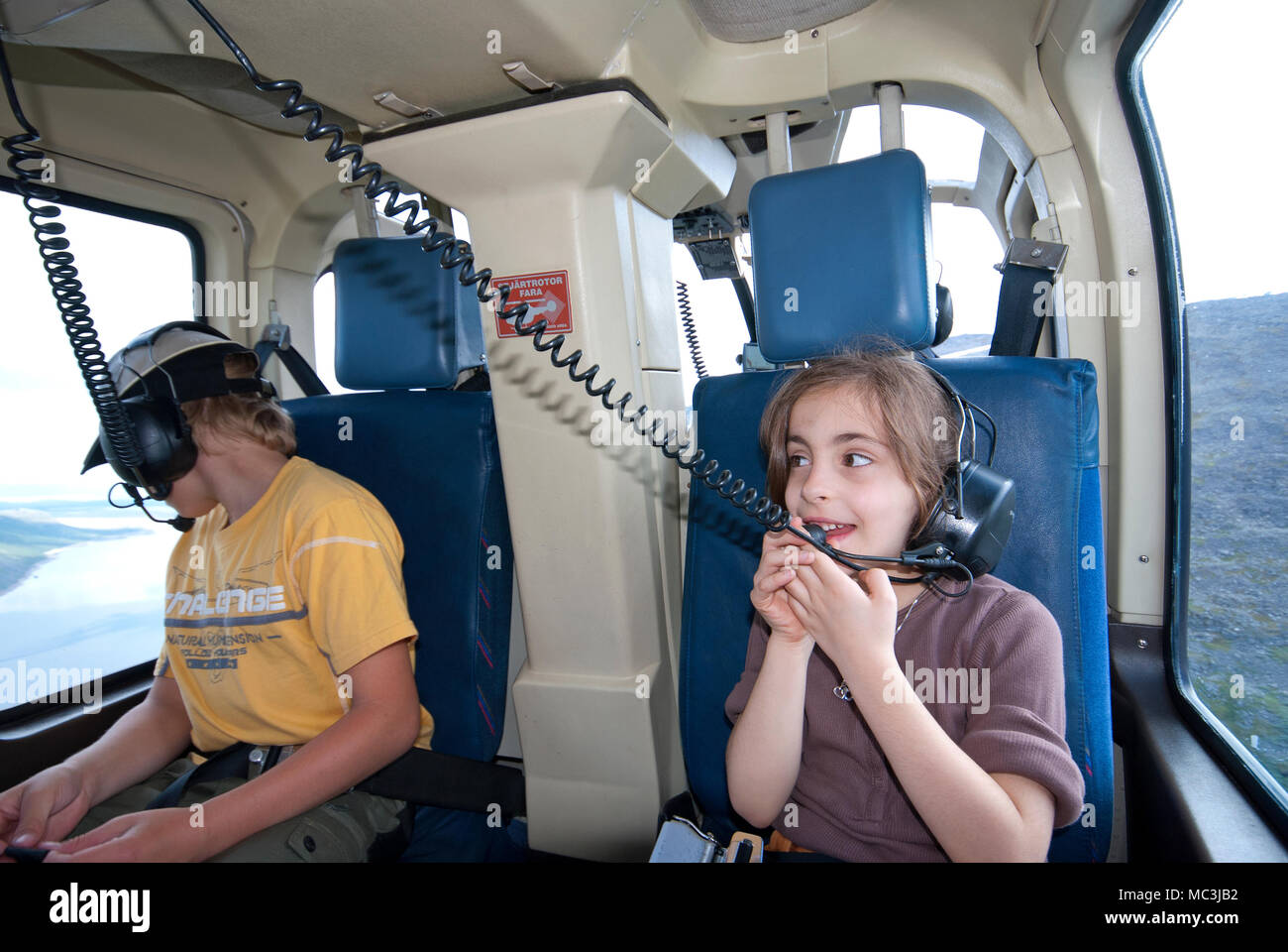 Children inside helicopter flying in Stora Sjofallet National Park ...