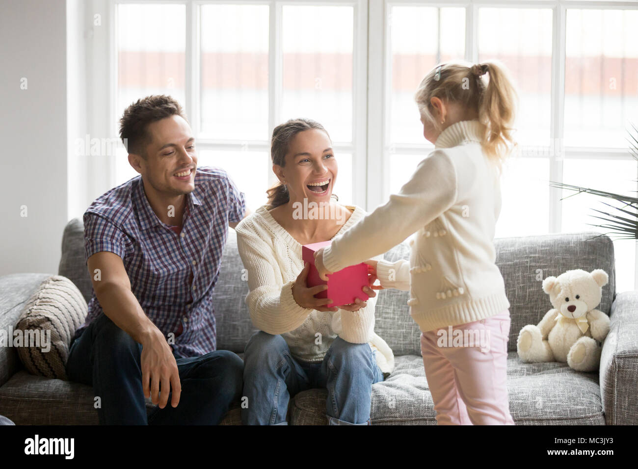 Daughter giving mom gift box making present on mothers day Stock Photo ...