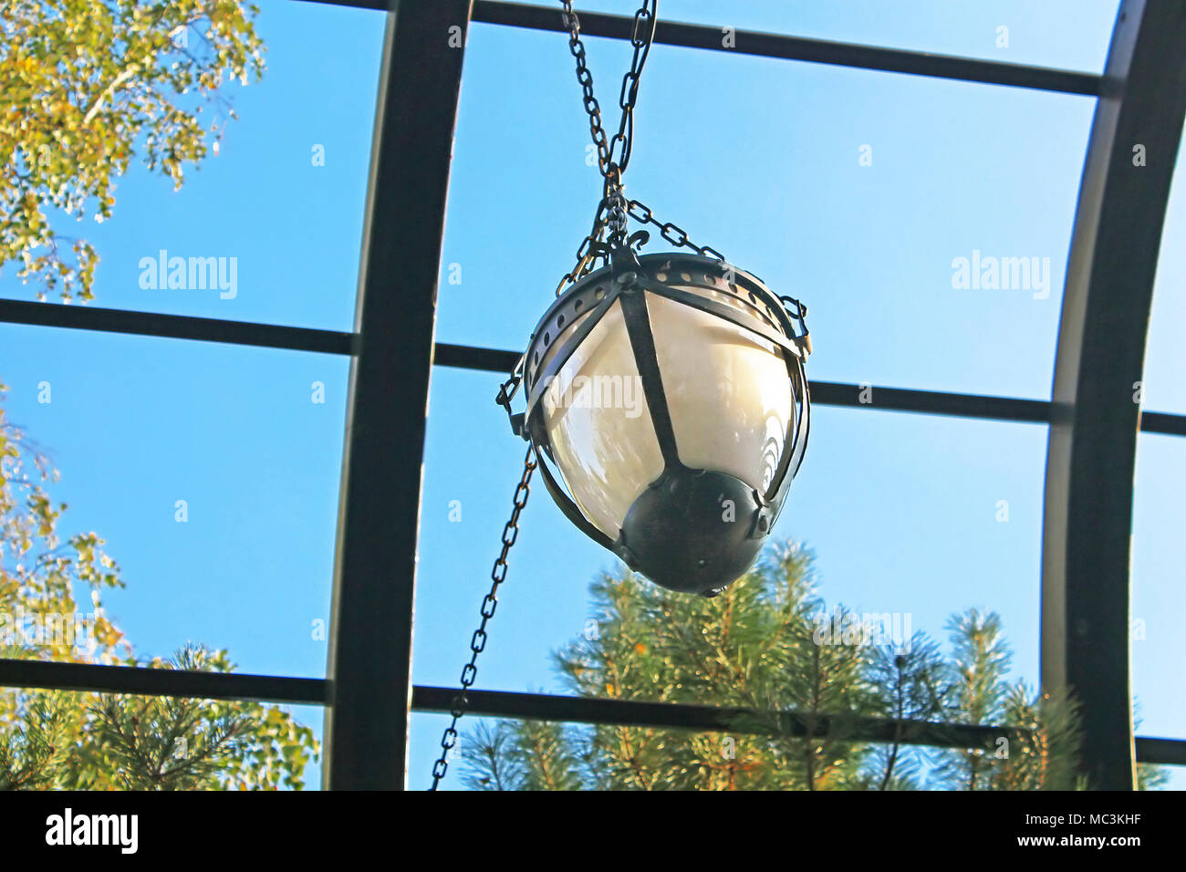 Wrought iron arbor with lantern Stock Photo - Alamy
