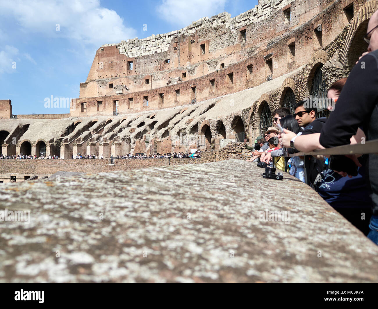 Low angle view of tourists inside of the Colosseum during the day with ...