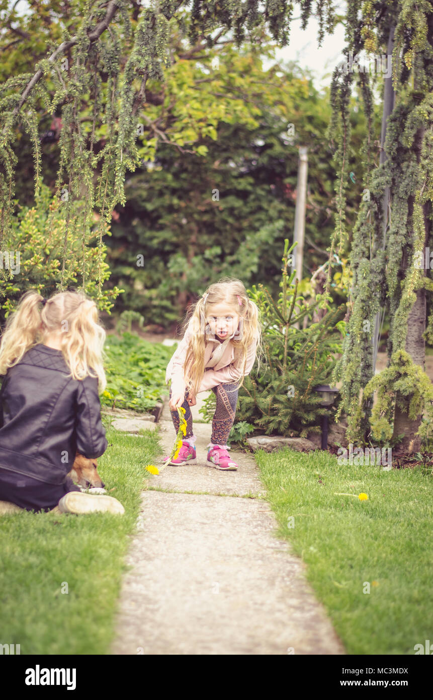 two girls playing in the garden Stock Photo - Alamy