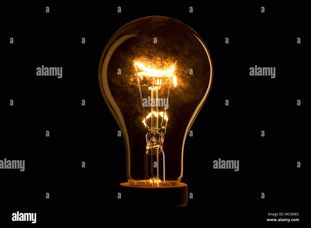 Abstract light bulb on the black background. Lamp light in the dark ...