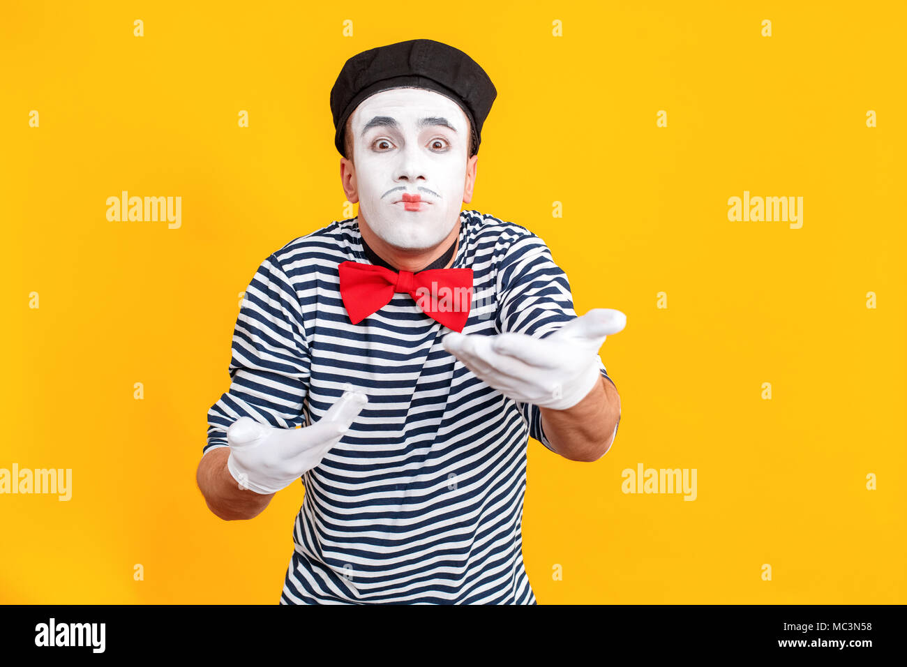 Mime man looking at camera and say take it please. Emotions and ...