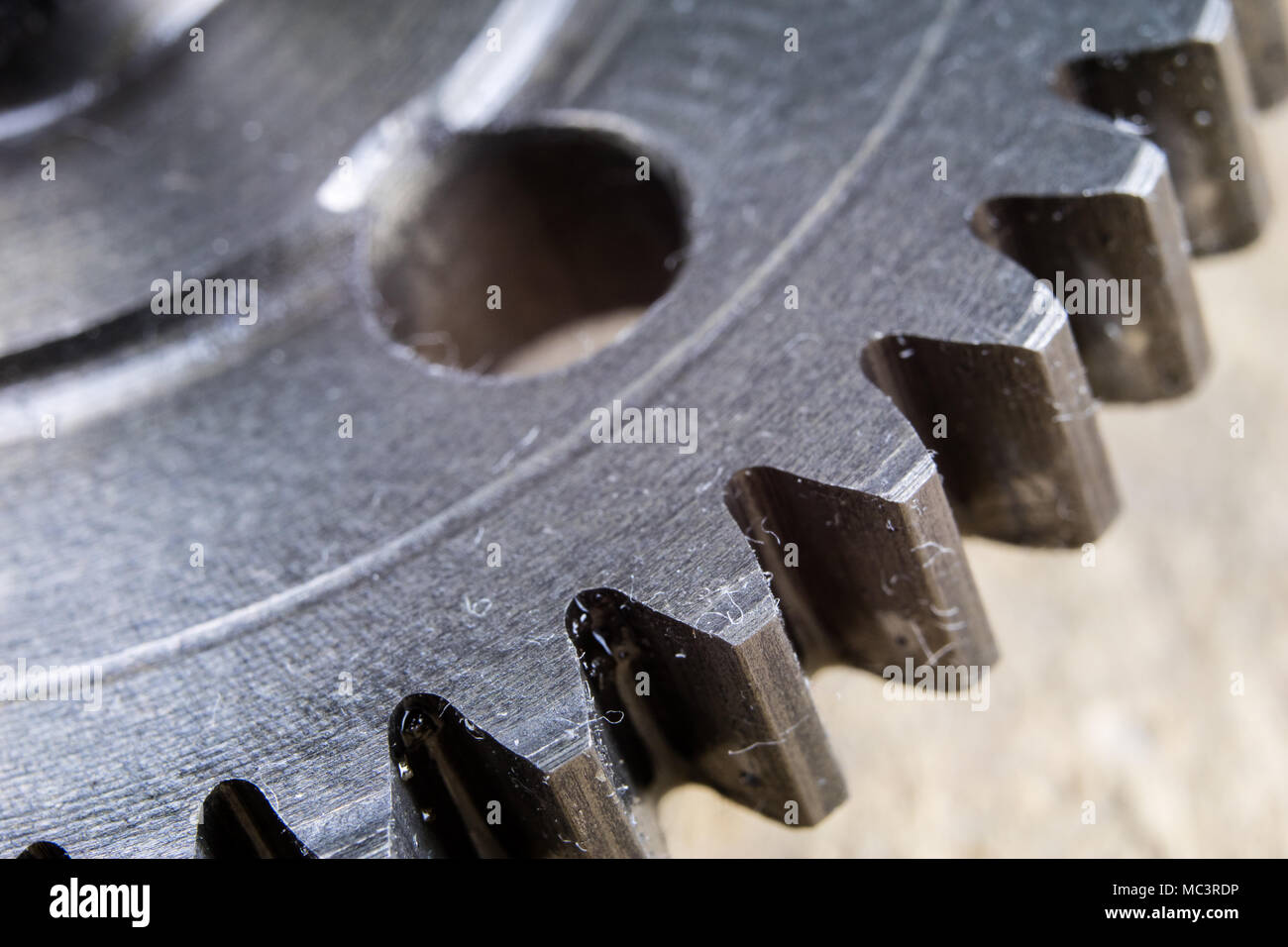 Metal gears covered with a layer of oil in a larger image. Spare parts ...